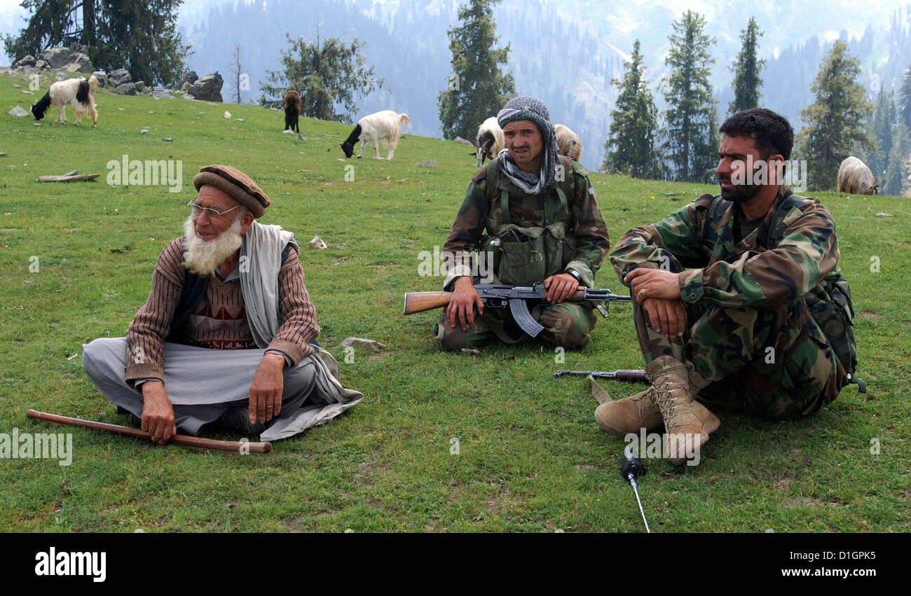 Two Afghan National Army Soldiers talk with a local Afghan July 19 ...