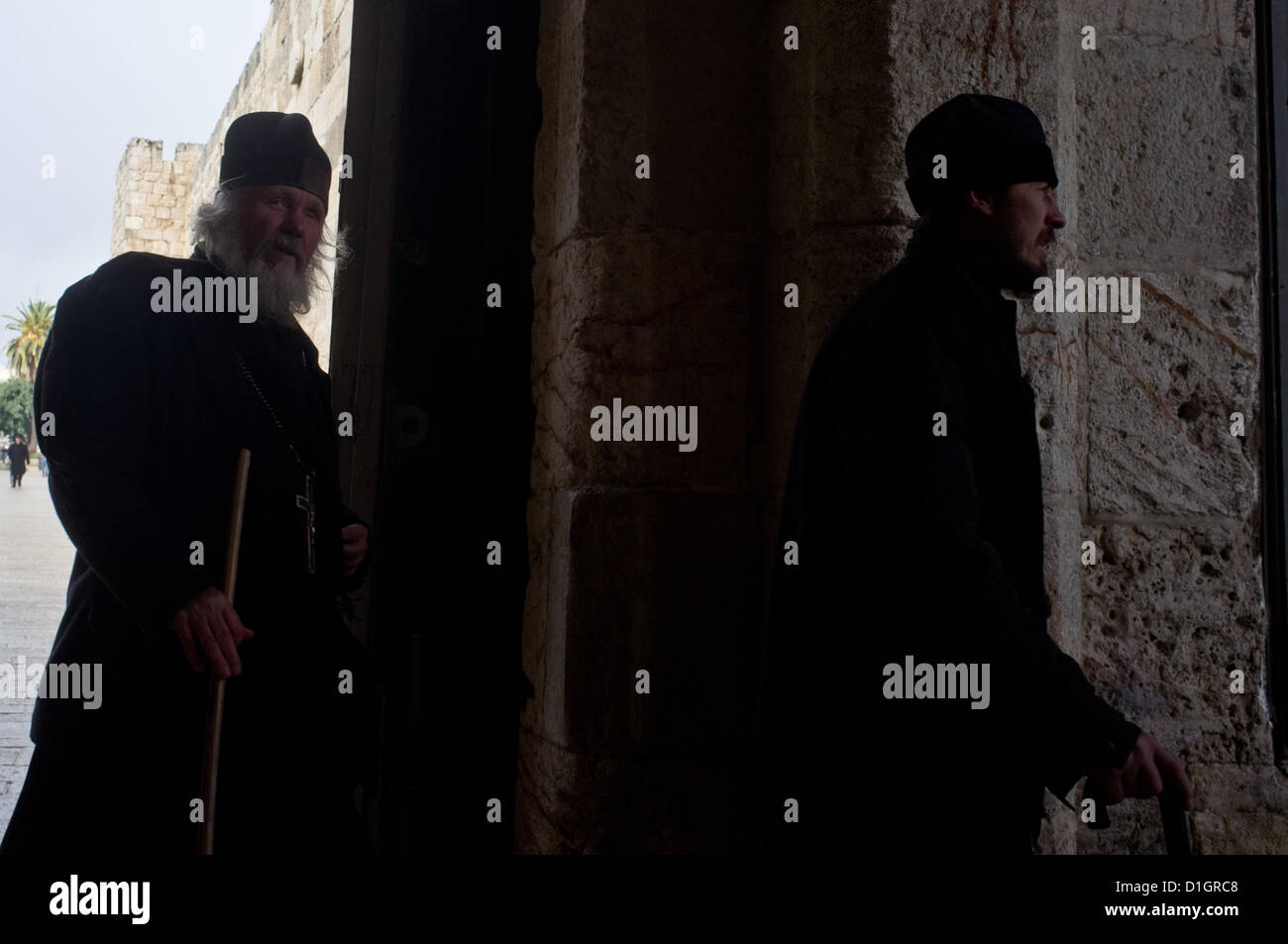 Two unrelated priests with walking sticks enter the Old City through ...