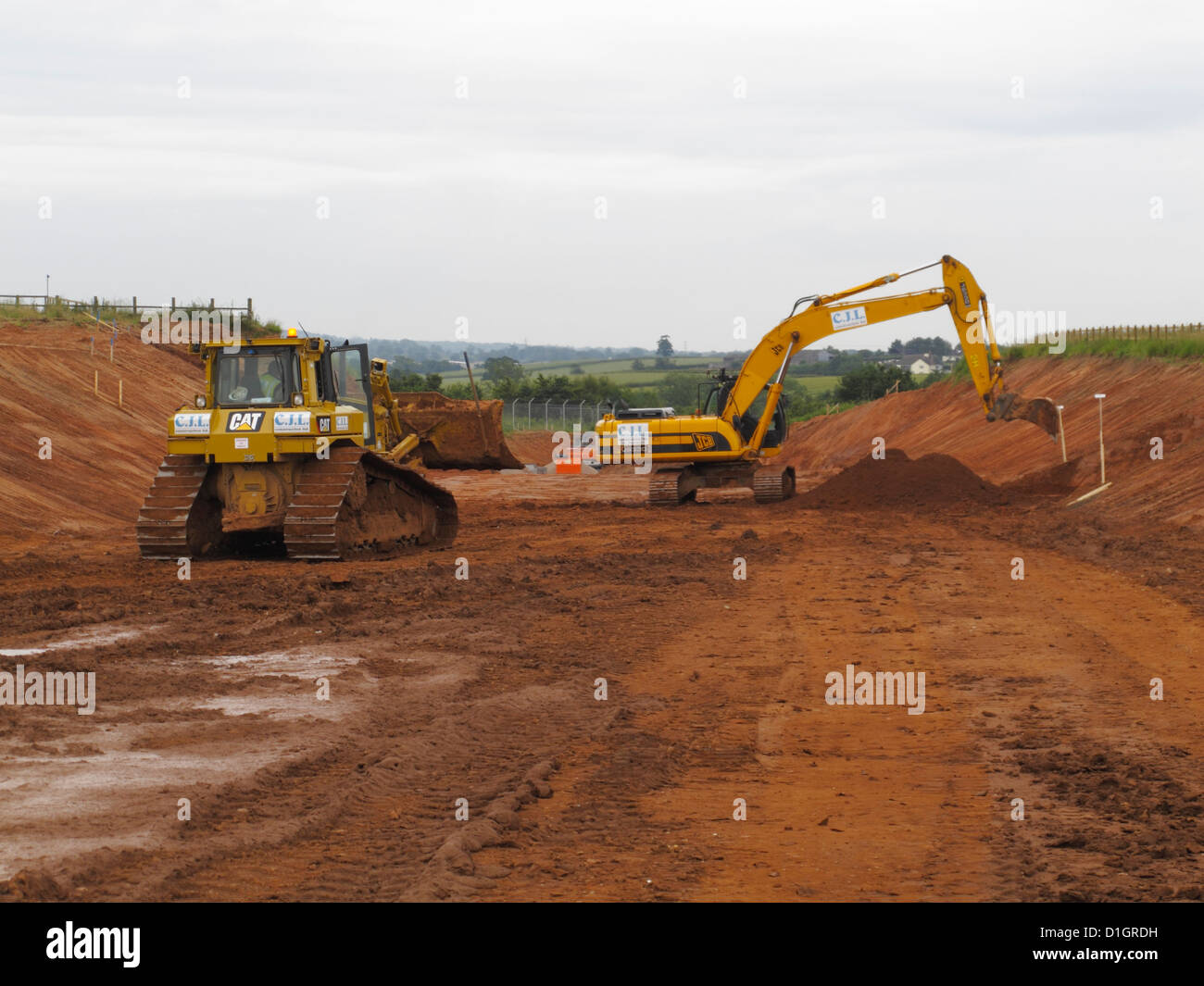 Caterpillar bulldozer and jcb tracked excavator digging cutting ...
