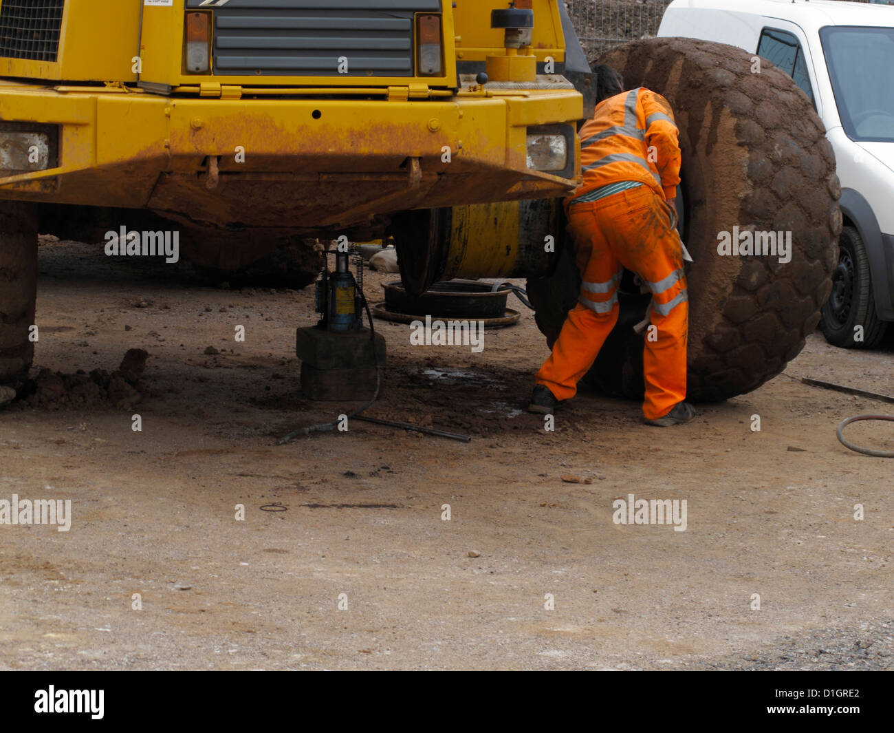MobileTire Tyre fitter repairing puncture on large whee of Volvo dumper ...