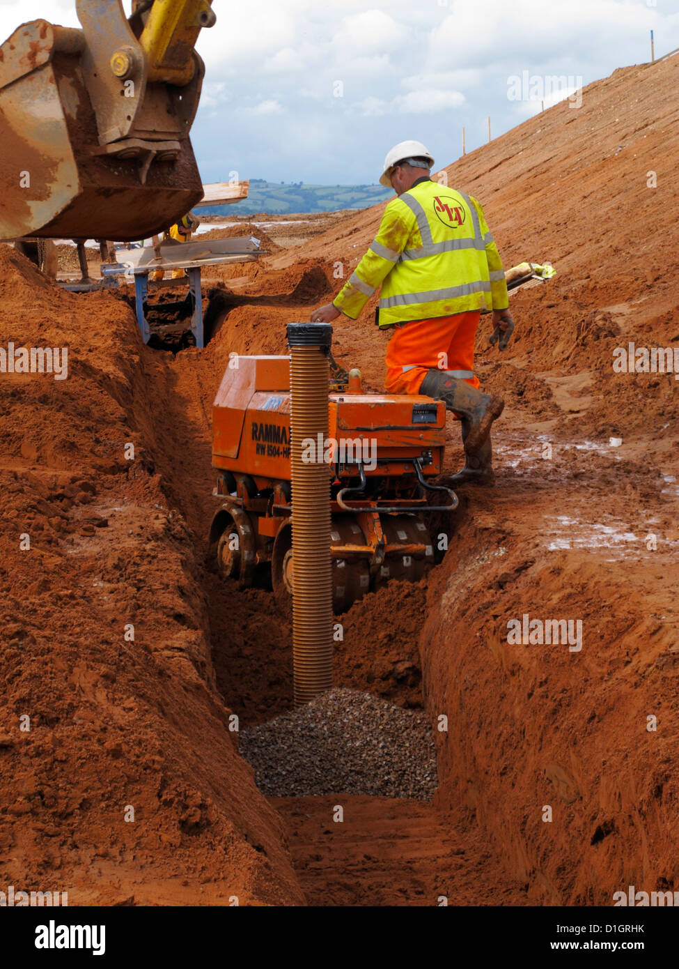 Backfilling drainage trench compacting soil using a remote control ...