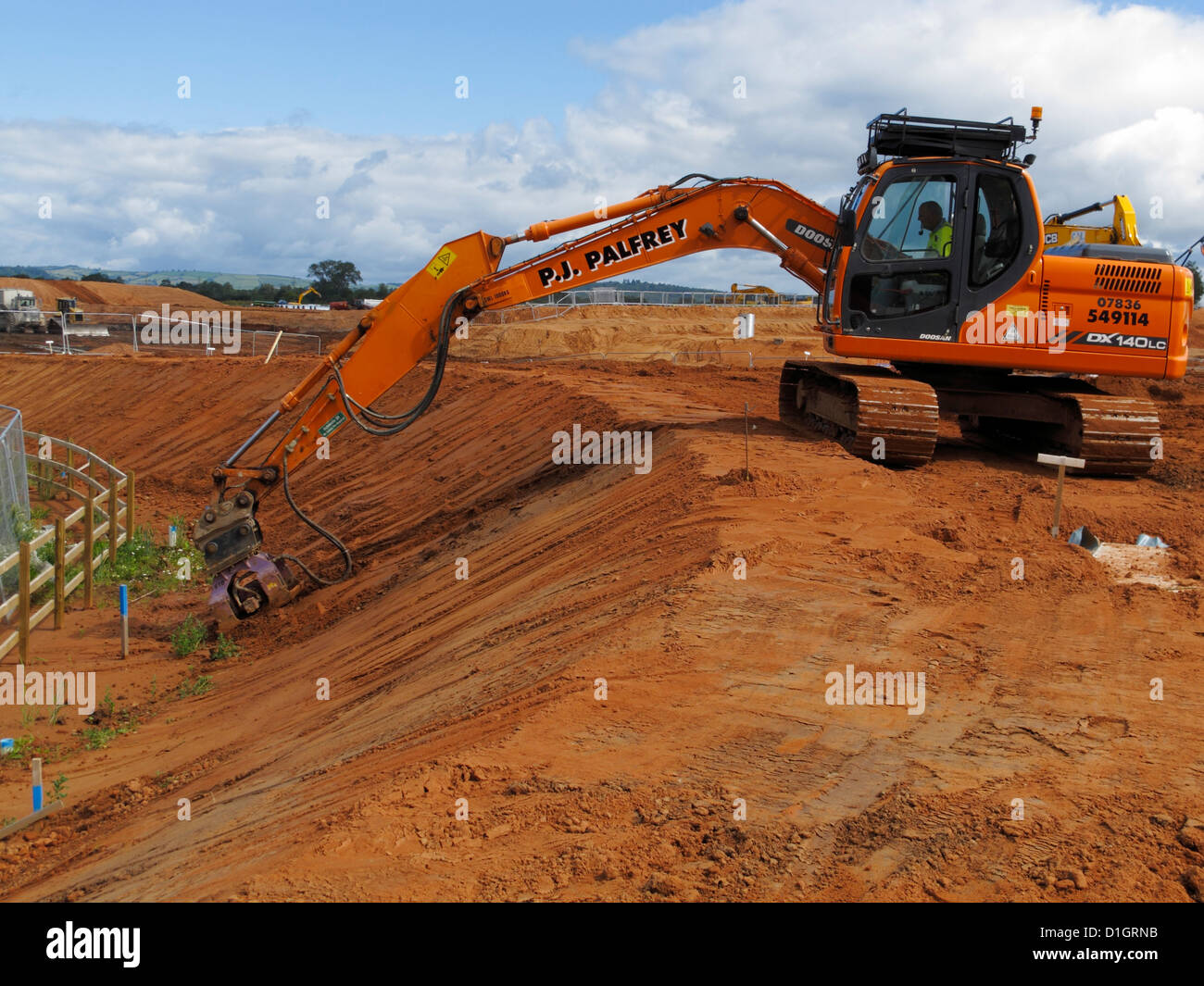 Excavator mounted hydraulic vibrating plate compacter compacting ...