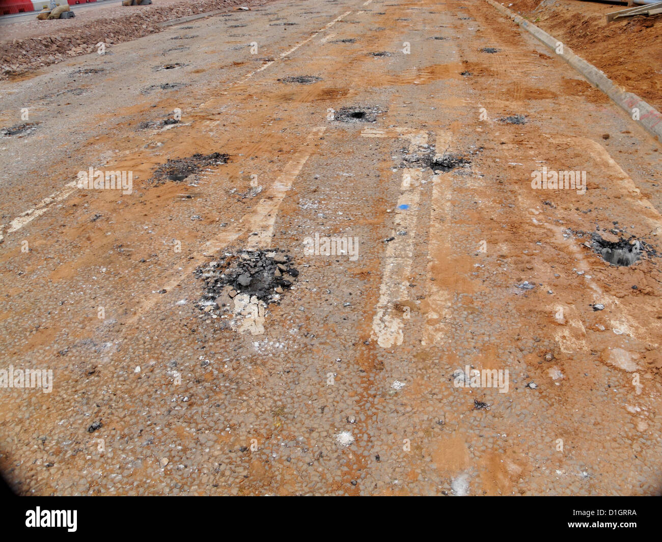 Existing road perforated by heavy digger mounted breaker uk Stock Photo ...