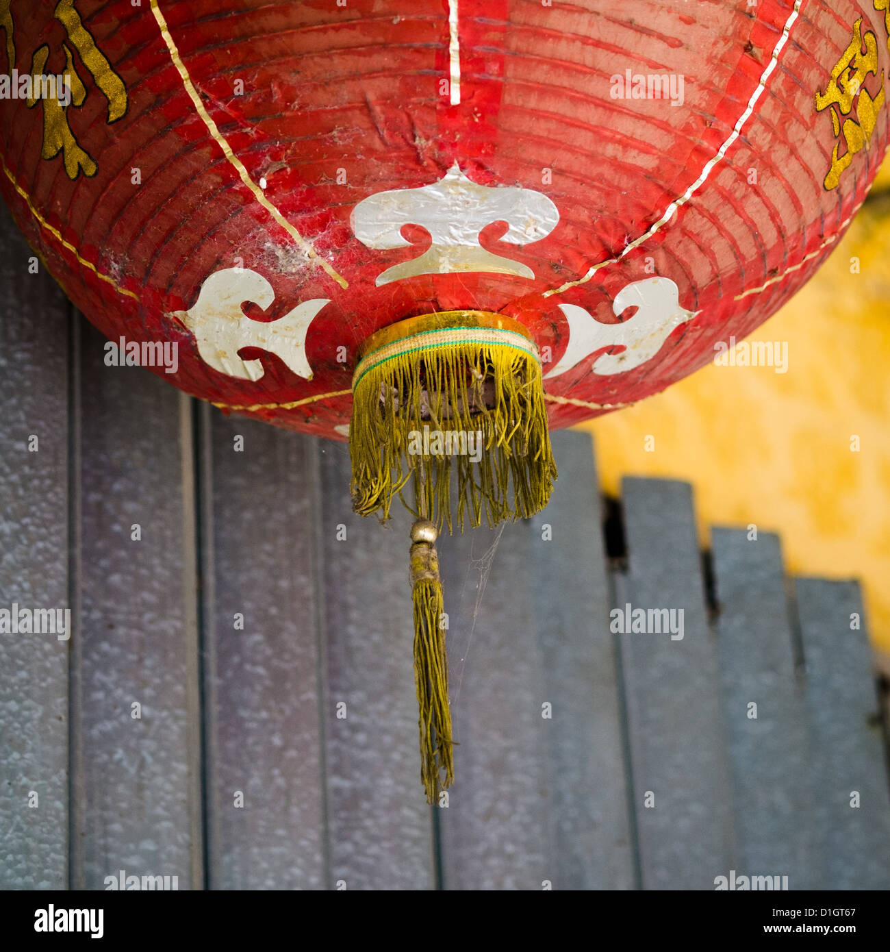 Chinese style lantern suspended from a ceiling contrasting with ...