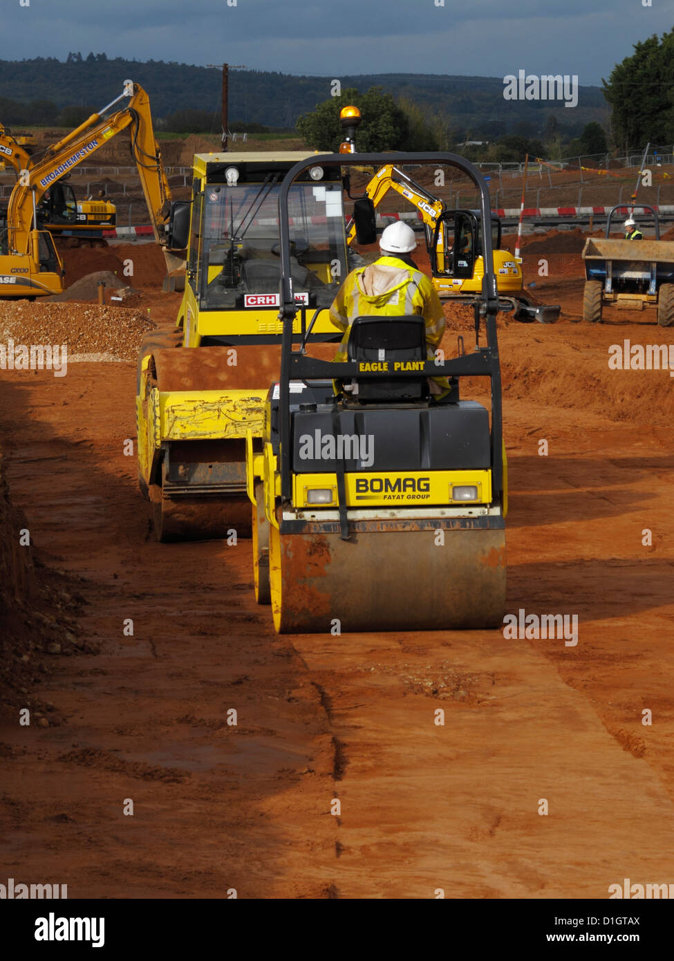Bomag road roller compacting compaction of fill soil during earthworks ...
