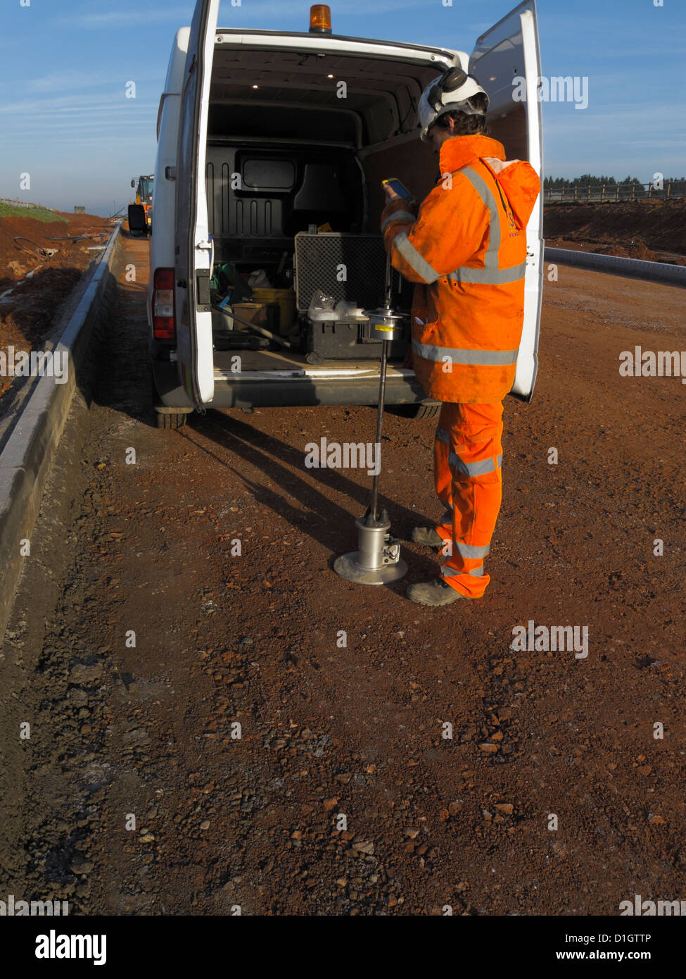 Soils laboratory technician doing Dynamic Plate Bearing test apparatus ...