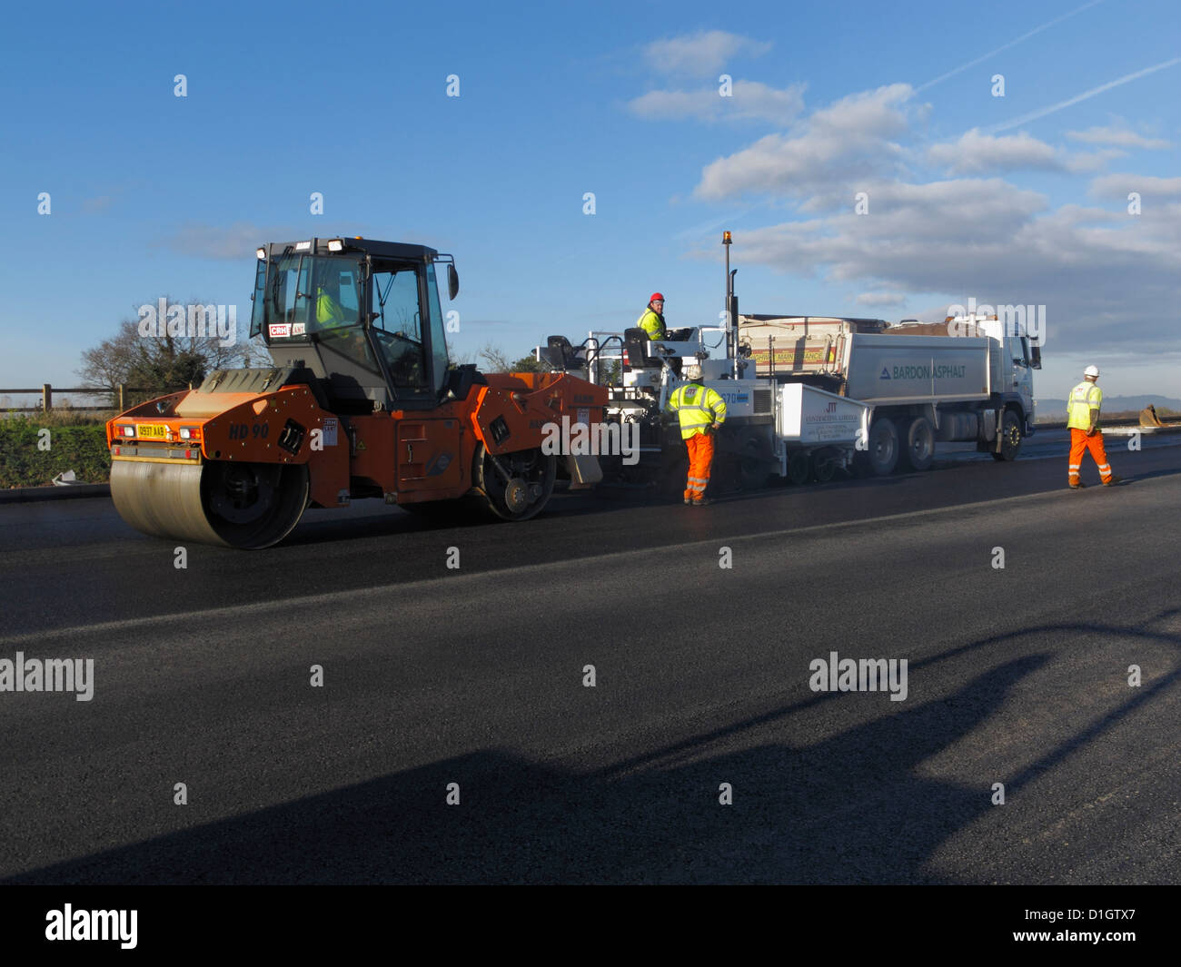 A Civil Engineering contractor highway maintenance gang laying asphalt ...