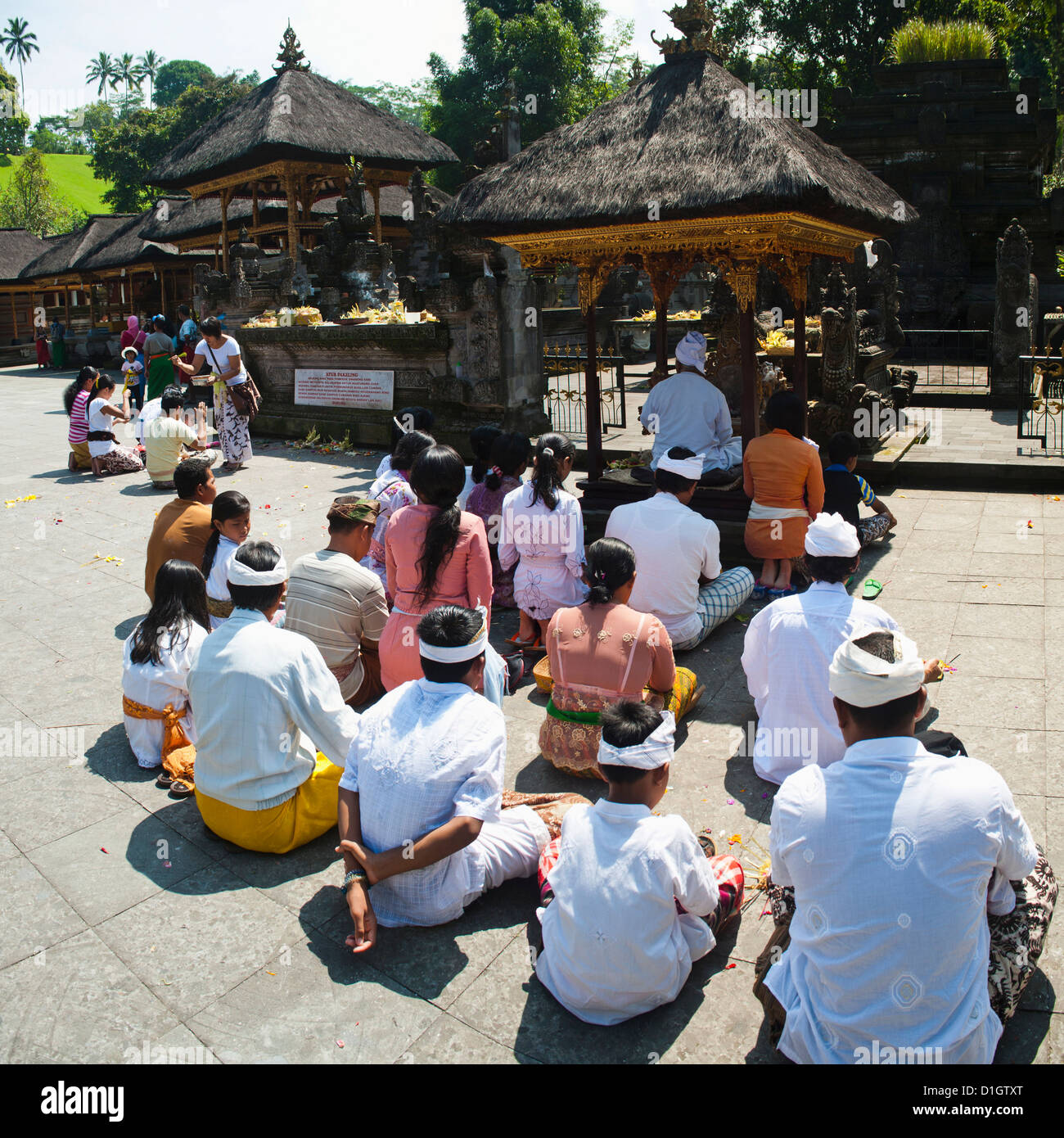 Group of Hindu people praying at Pura Tirta Empul Temple, Bali ...