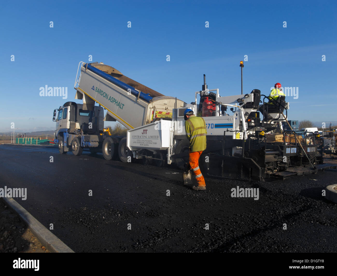 A Civil Engineering contractor highway maintenance gang laying asphalt ...