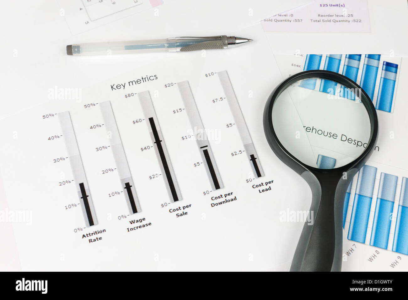 Business graph printed on the white paper with a magnifier on it Stock ...