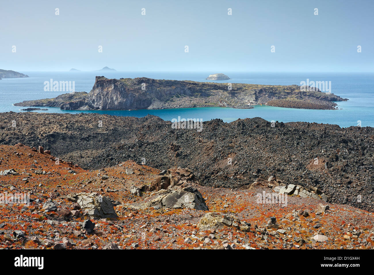 Lava and volcanic rocks with Palea Kameni and Aspronisi islands in the ...