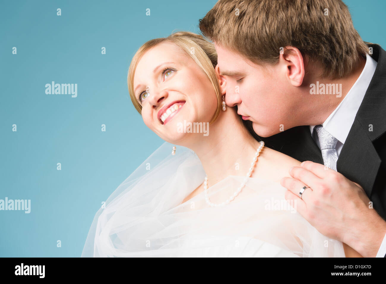 Close up happy wedding couple, groom kissing bride neck, blue ...