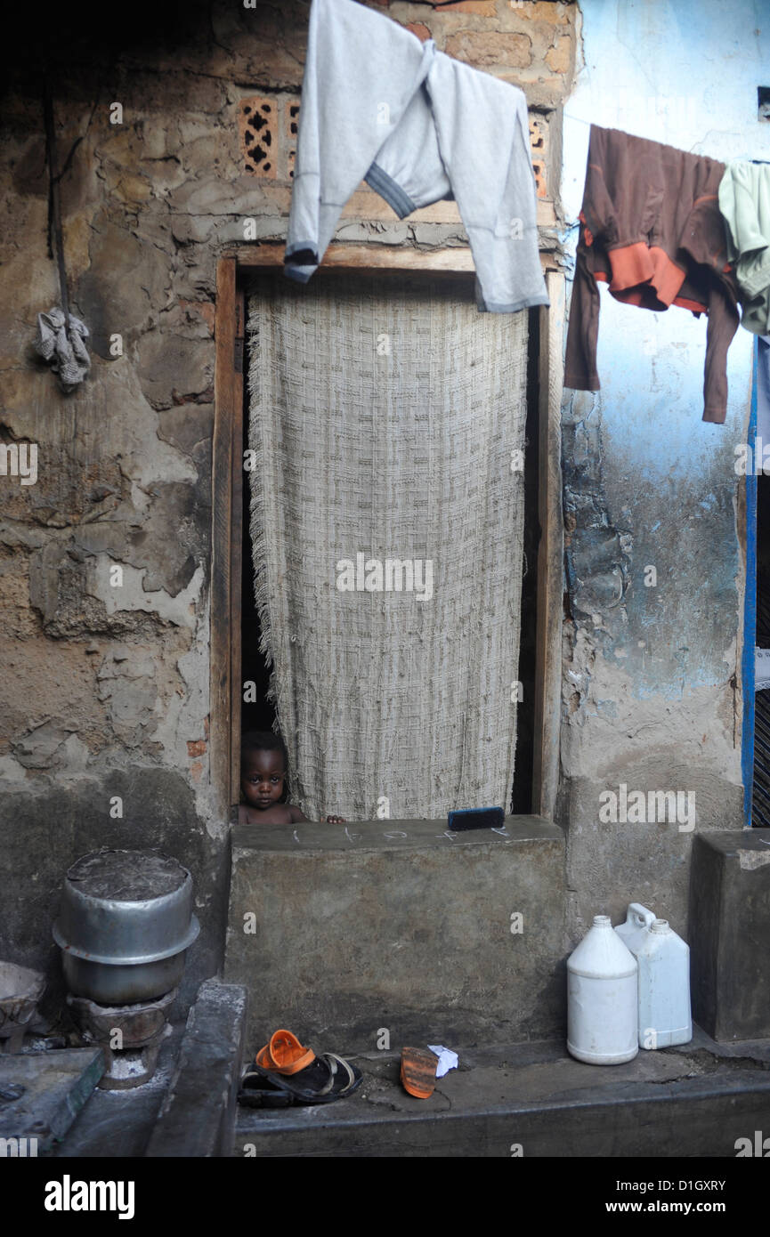 small african cute baby poking through a door Stock Photo - Alamy