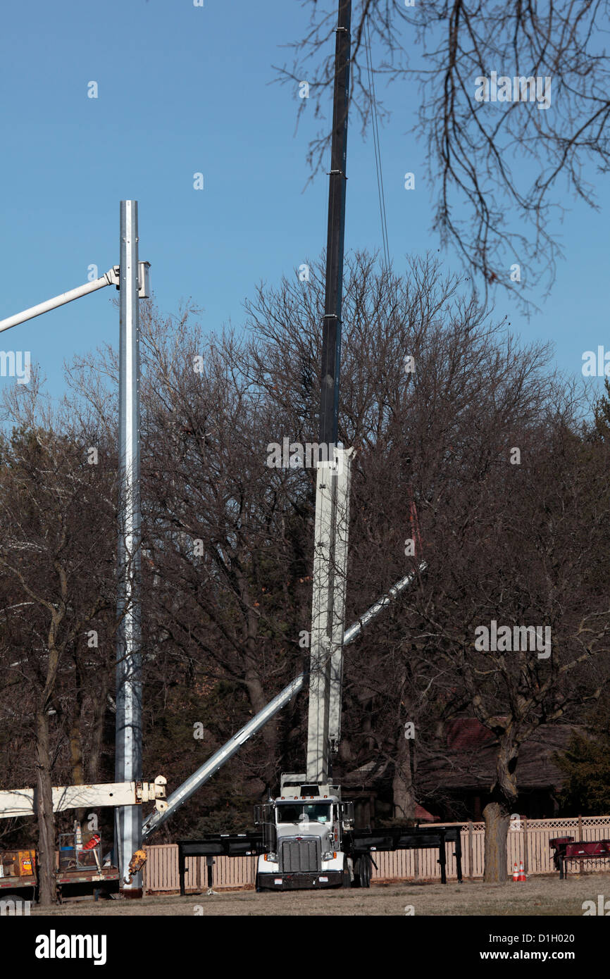 Crane lifting steel utility pole hi-res stock photography and images ...