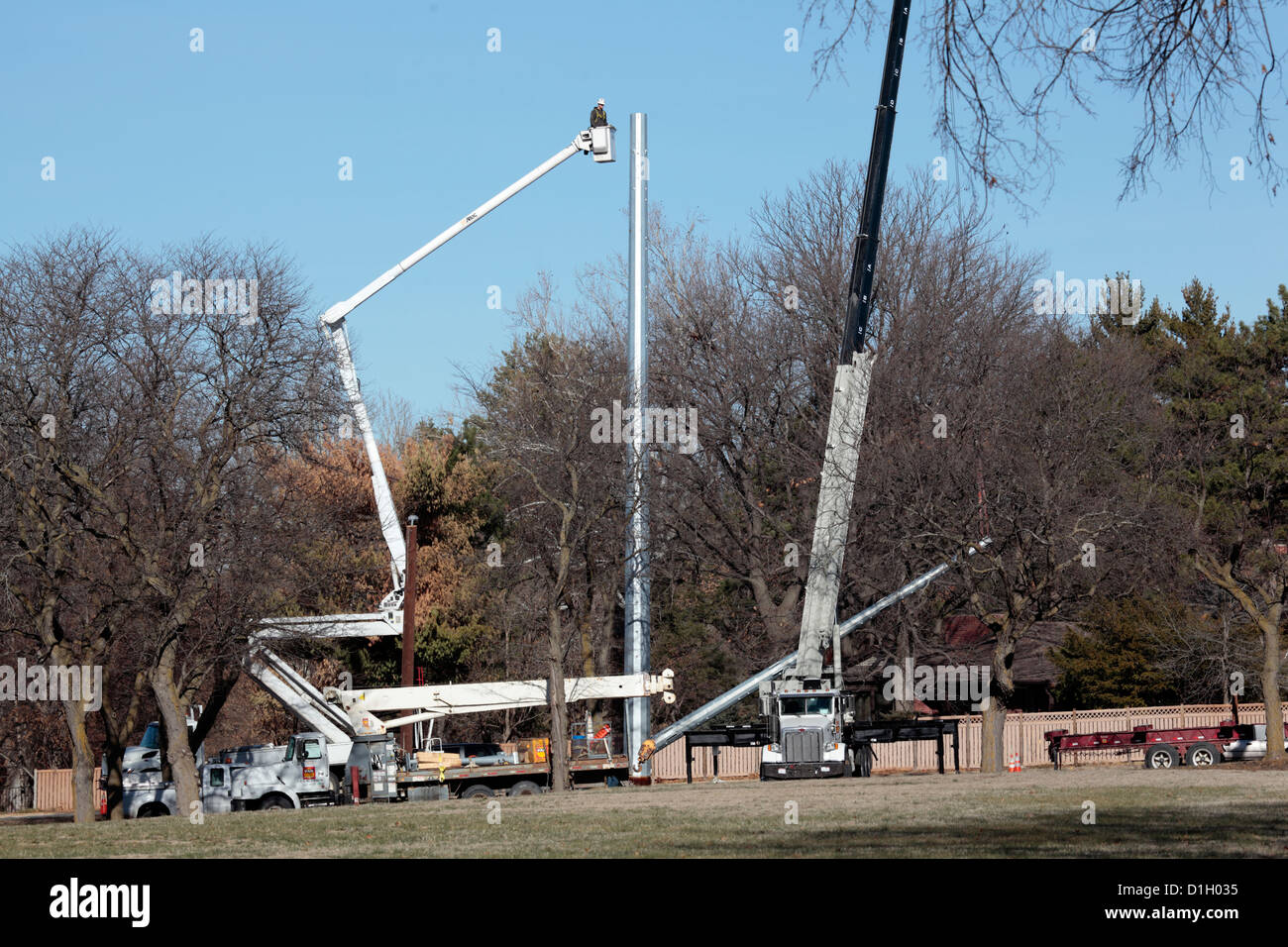Utility pole being lifted into place Stock Photo - Alamy