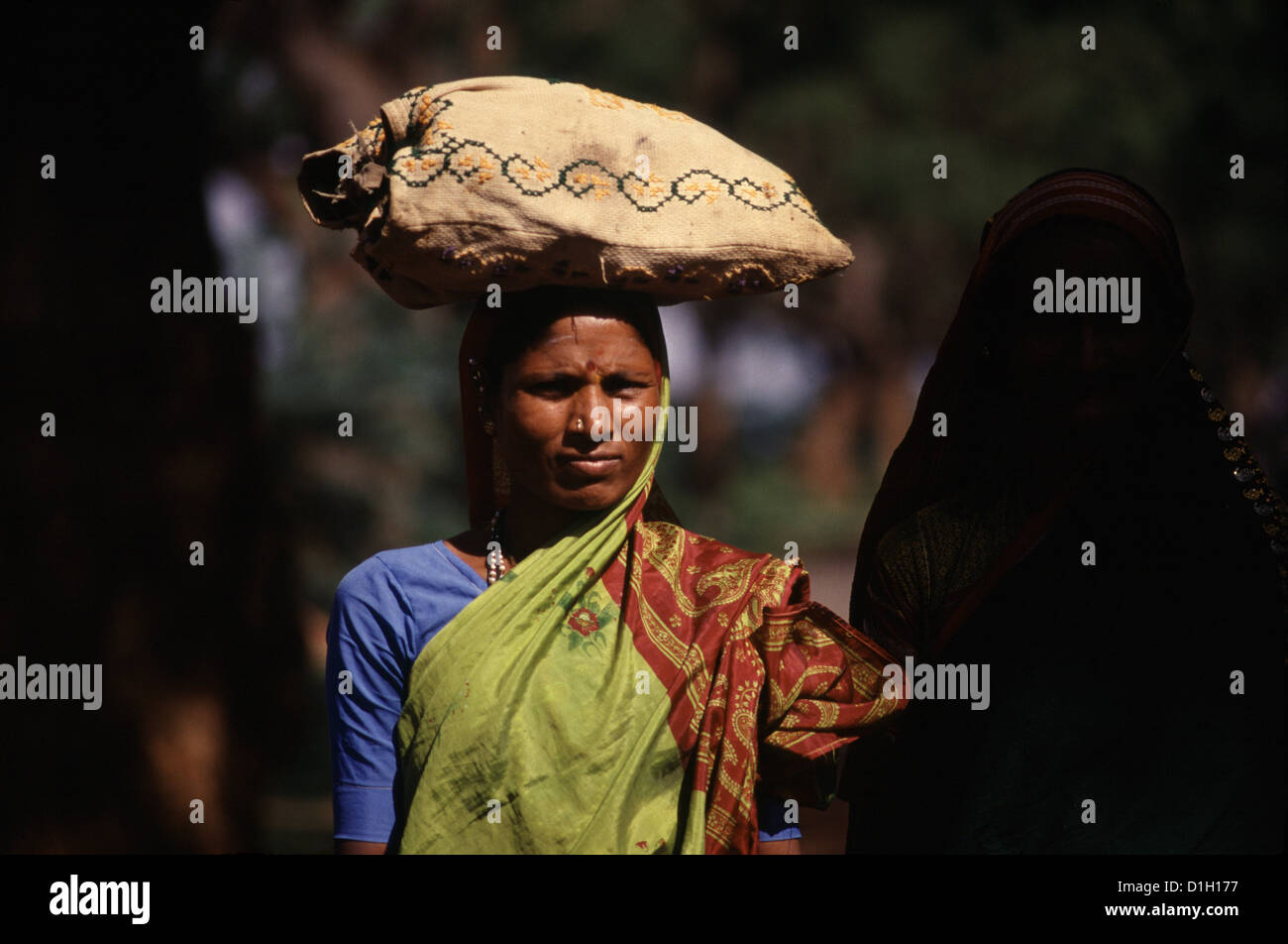 A villager carrying a sack on her head in Bijapur in Karnataka state ...