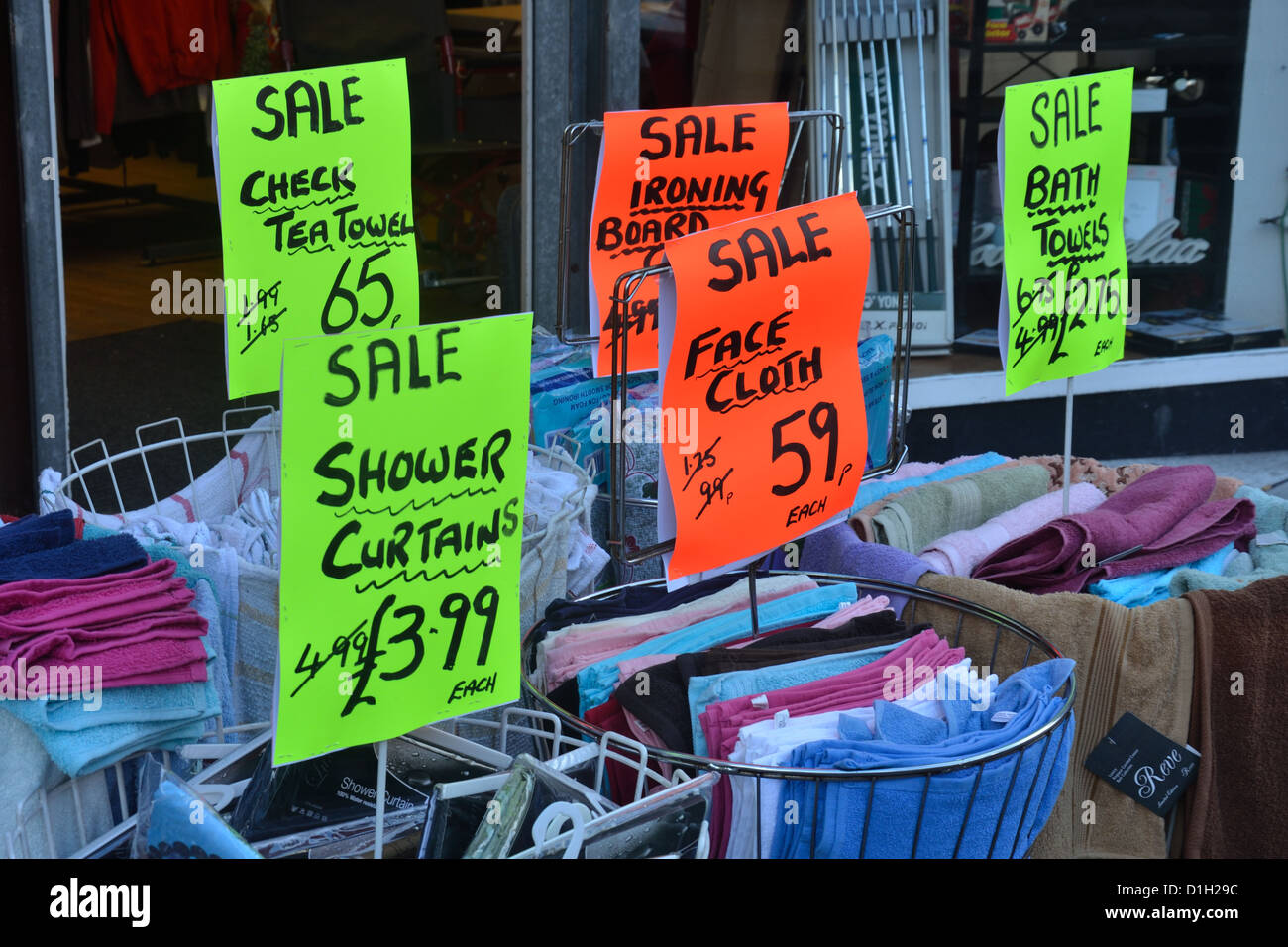 Colorful reduction signs outside shop Stock Photo - Alamy
