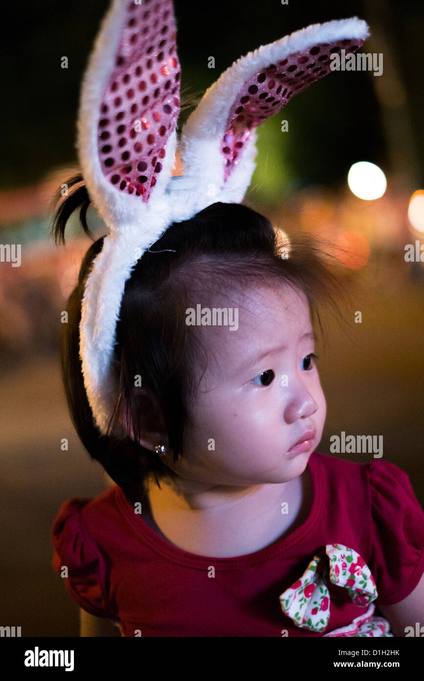 A young child with large bunny ears during the Lunar Festival in Hanoi ...
