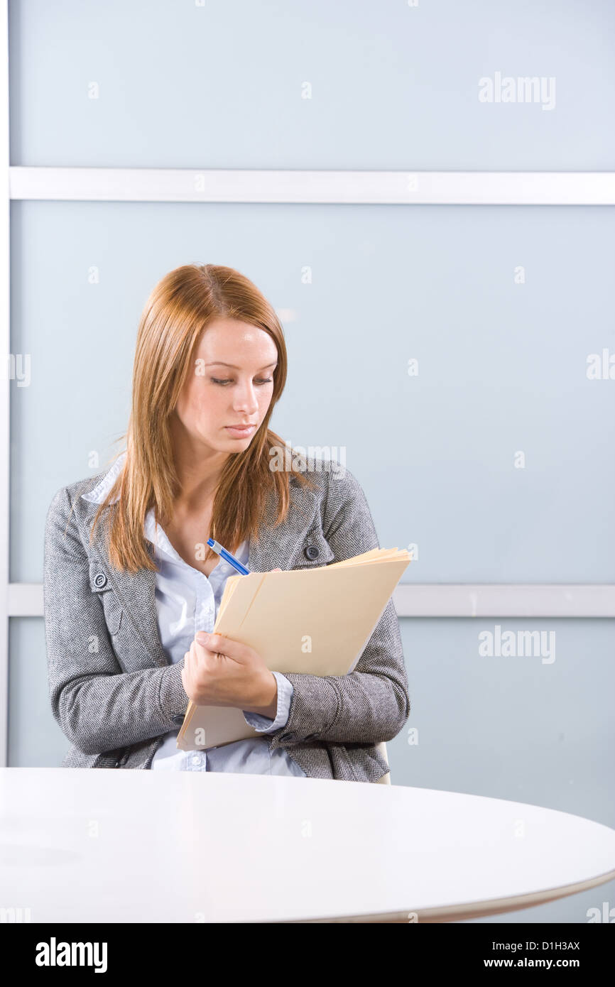 Business Woman Writing notes at desk in a modern office Stock Photo - Alamy