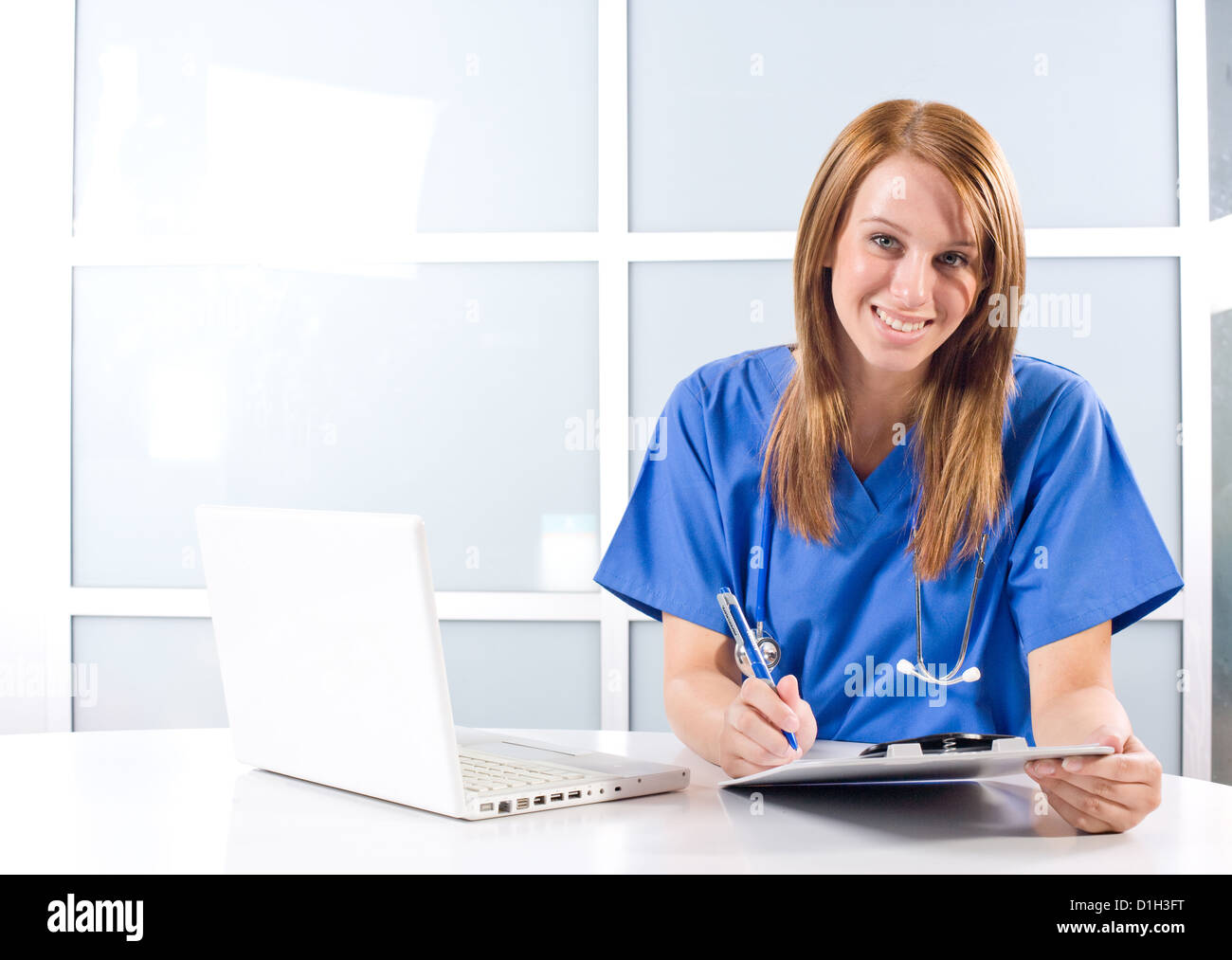 Female Nurse in a modern office holding a chart Stock Photo - Alamy