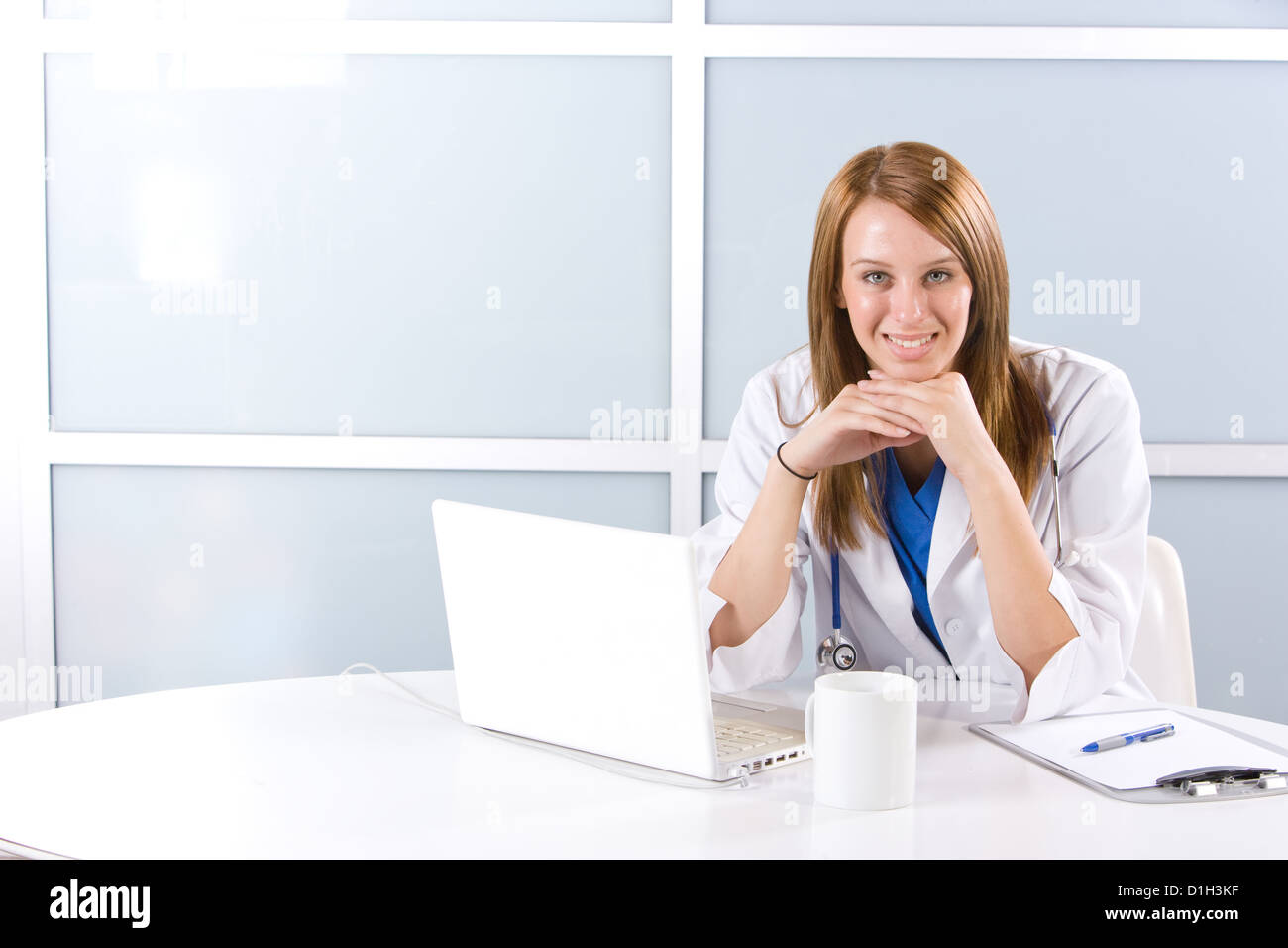 Female doctor on computer at desk in a modern office Stock Photo - Alamy