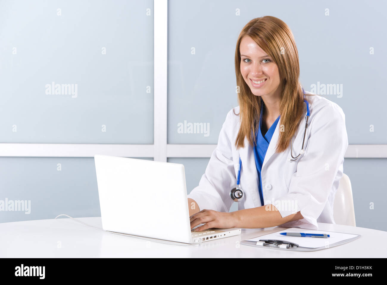 Female doctor on computer at desk in a modern hospital Stock Photo - Alamy
