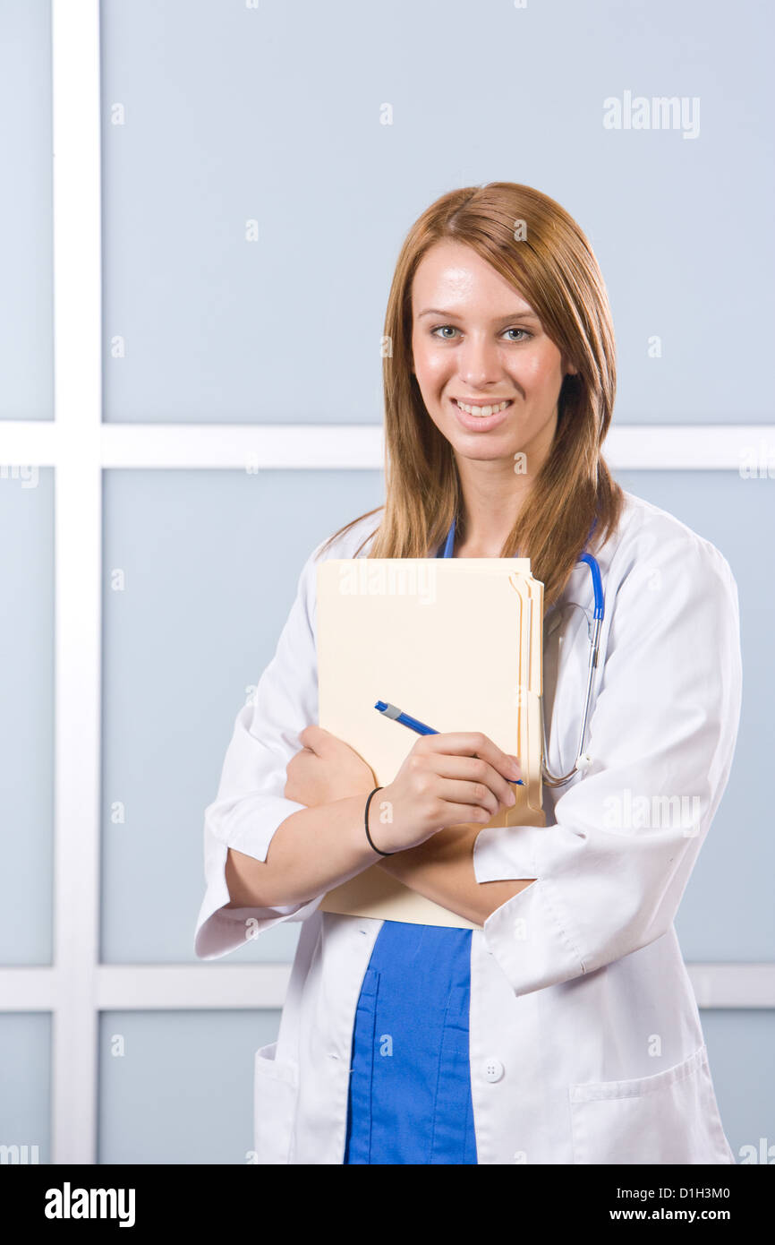 Woman doctor holding a chart in a modern office Stock Photo - Alamy