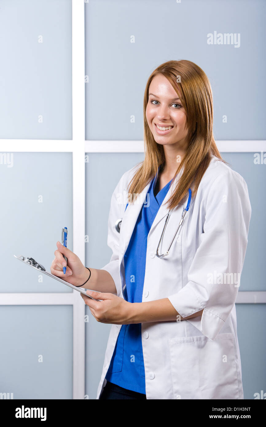 Woman doctor holding a chart in a modern office Stock Photo - Alamy