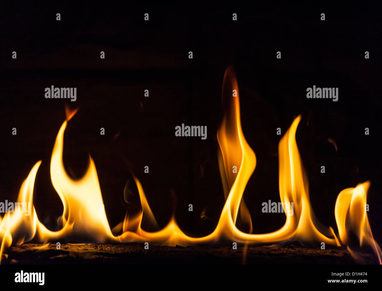 Flaming Log with black background Stock Photo - Alamy
