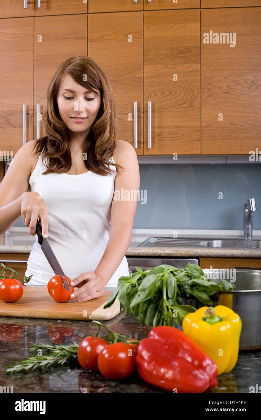 Woman preparing fresh vegetables in a Modern Kitchen Stock Photo - Alamy