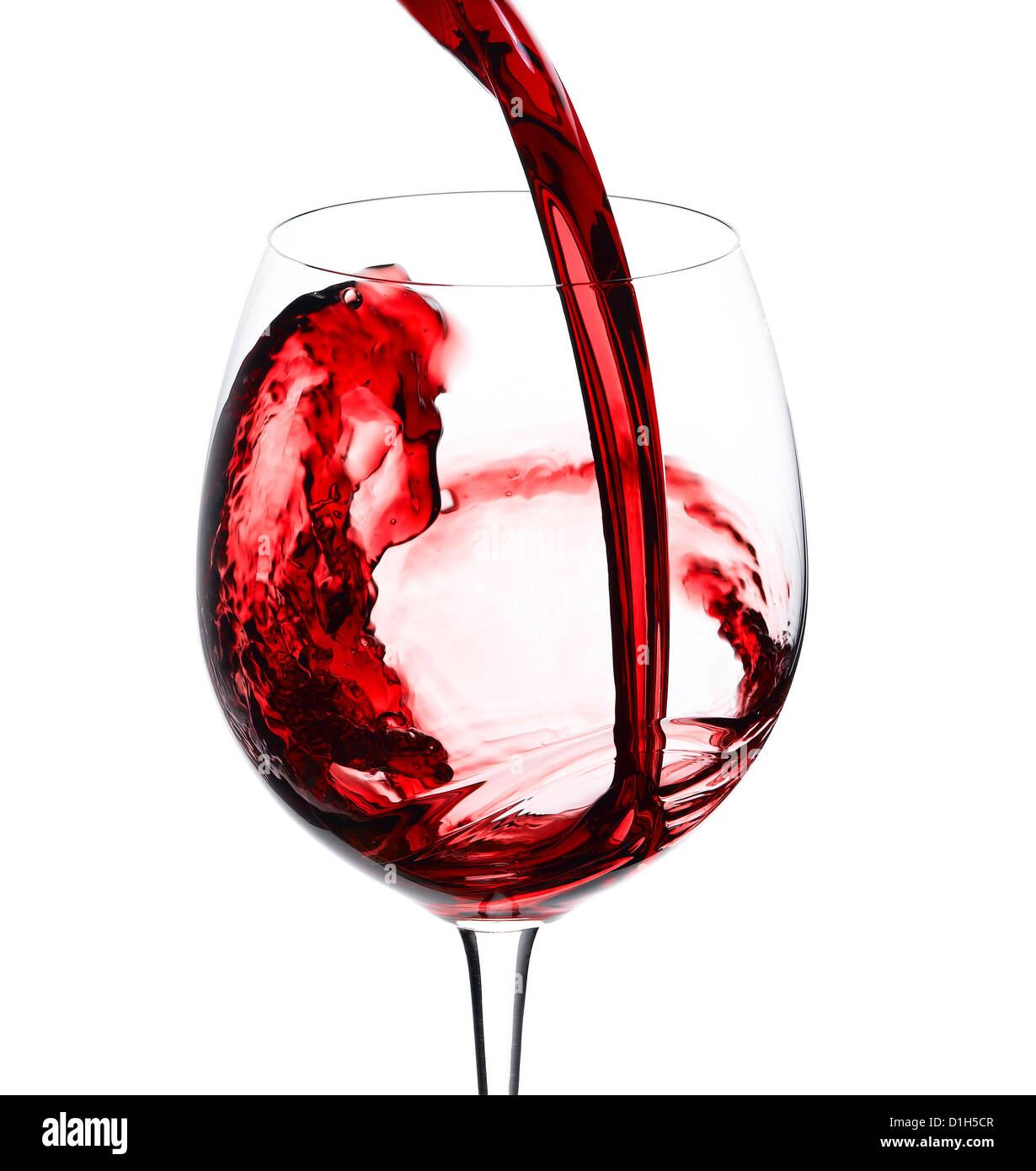 Pouring red wine to wine glass isolated on white Stock Photo - Alamy