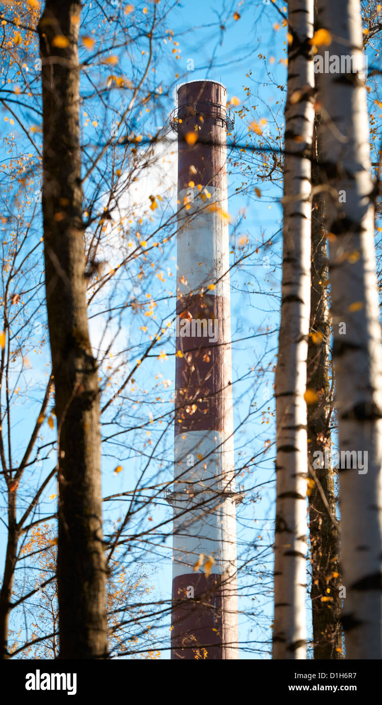 Factory chimney and trees Stock Photo - Alamy