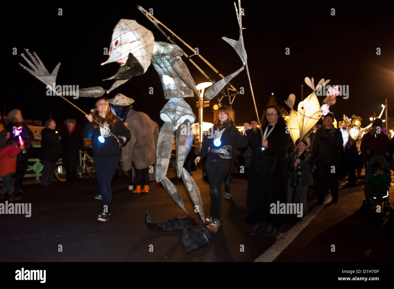 The parade reaches Madeira Drive. Burning the Clocks Lantern lit ...