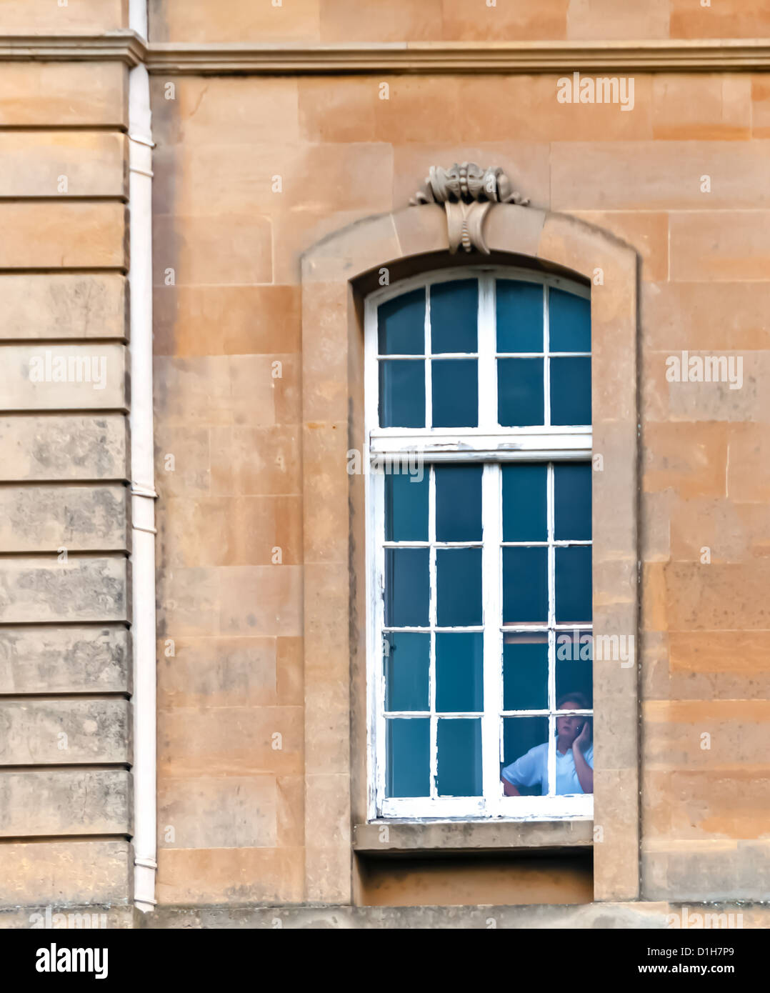 Using a Mobile while looking out of the window Stock Photo - Alamy