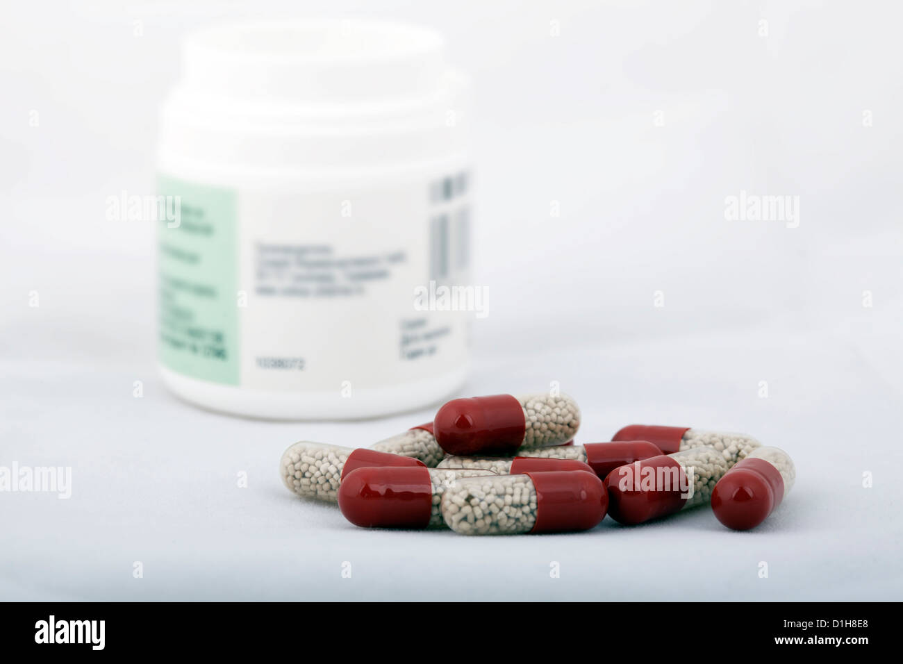 Pills and capsules with a bottle Stock Photo - Alamy