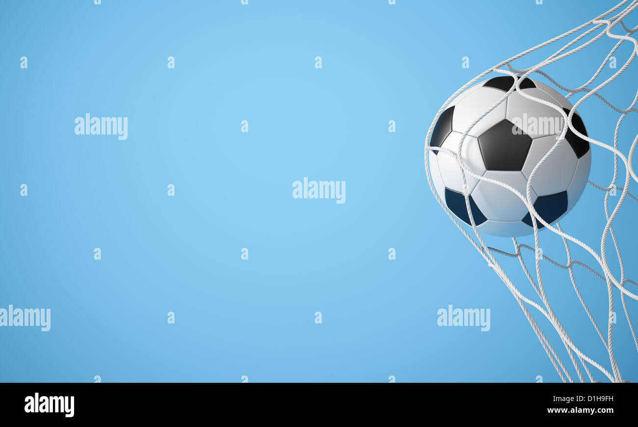 Soccer ball in net on blue background Stock Photo - Alamy