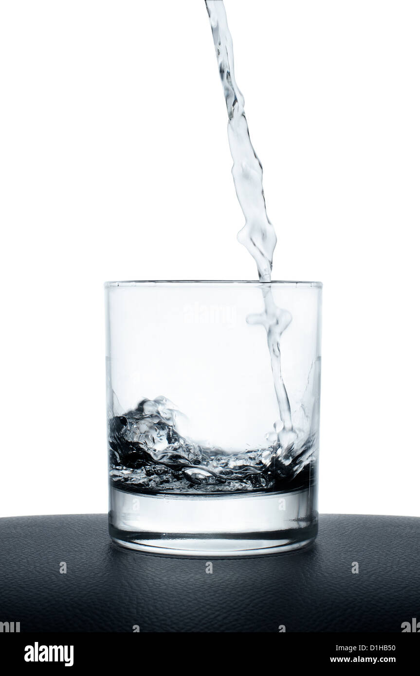 pouring water in a glass on white background Stock Photo - Alamy