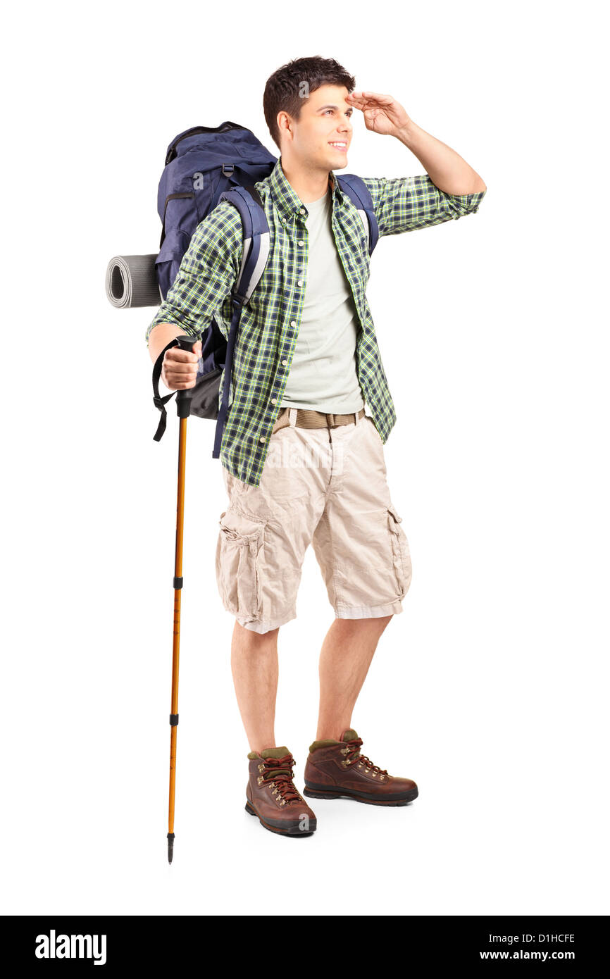 Full length portrait of a hiker with backpack looking isolated on white ...