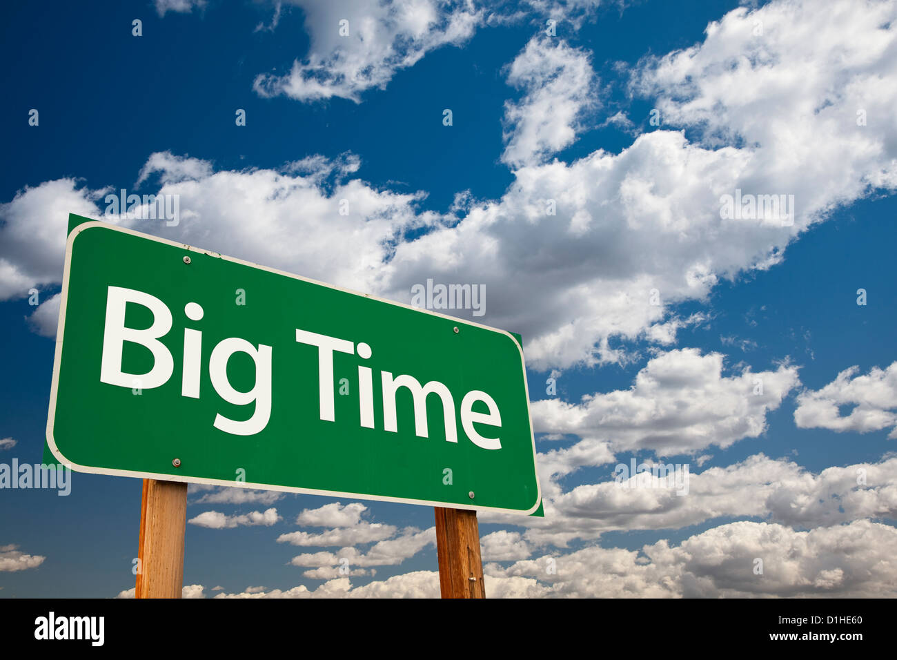 Big Time Green Road Sign Over Dramatic Clouds and Sky Stock Photo - Alamy