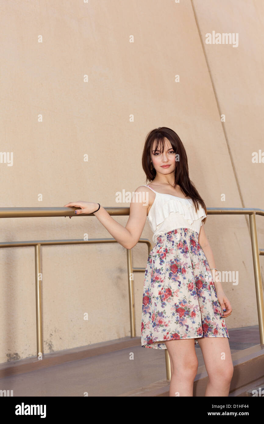 Pretty woman standing on steps Stock Photo - Alamy