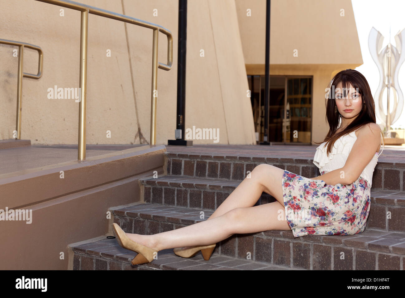 Pretty woman sitting on steps Stock Photo - Alamy