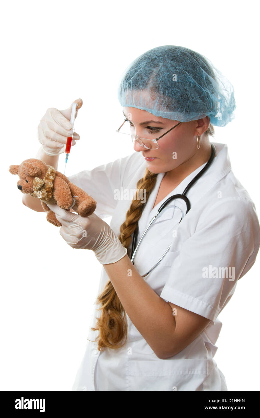 Female medical doctor or nurse makes injection teddy bear isolated on ...