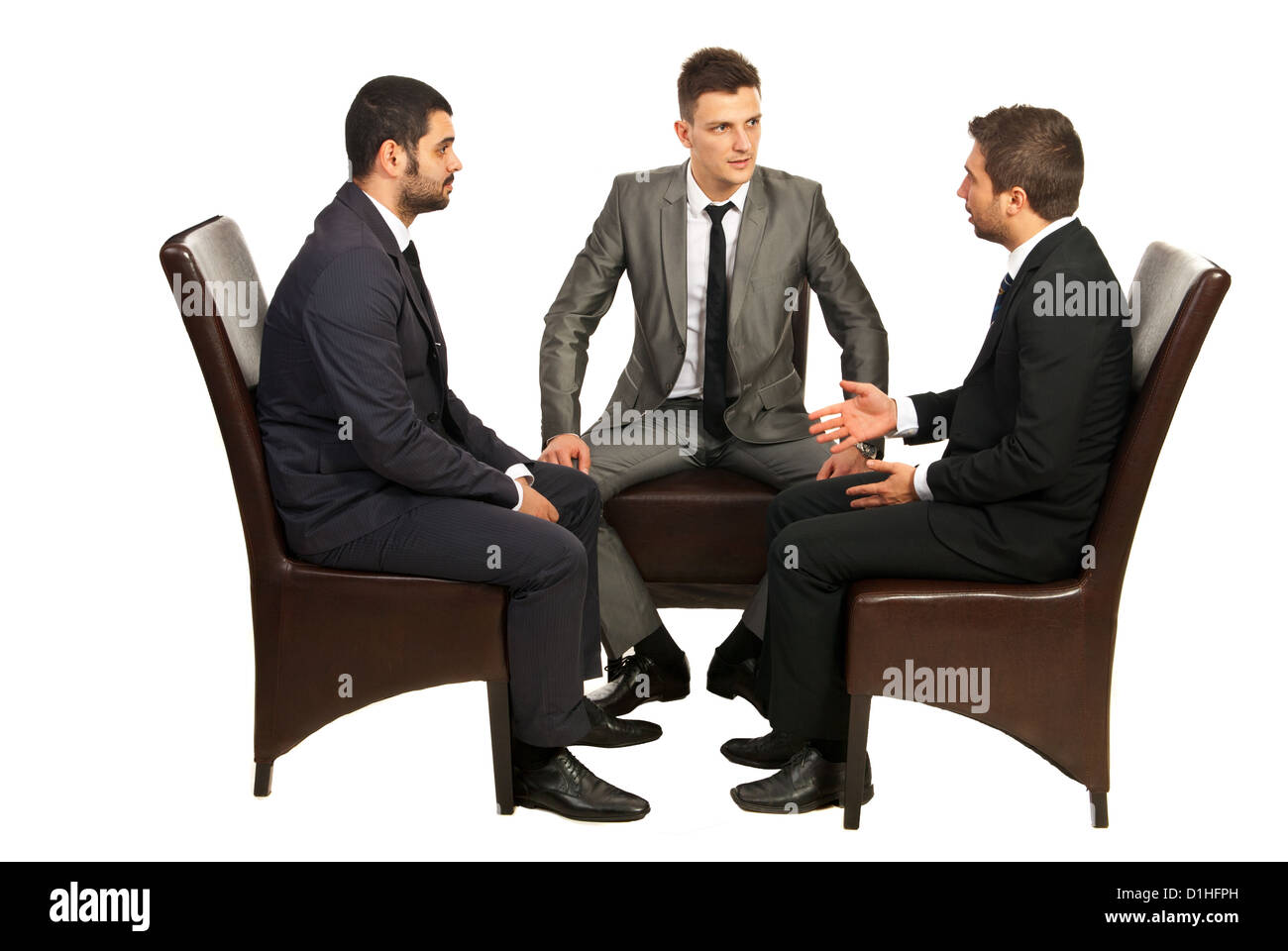 Serious conversation of three business men sitting on chairs isolated ...