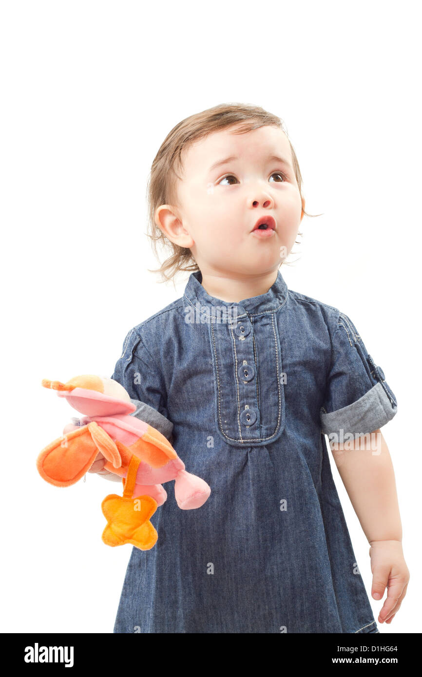 Adorable little baby girl with toy in the studio, isolated on white ...