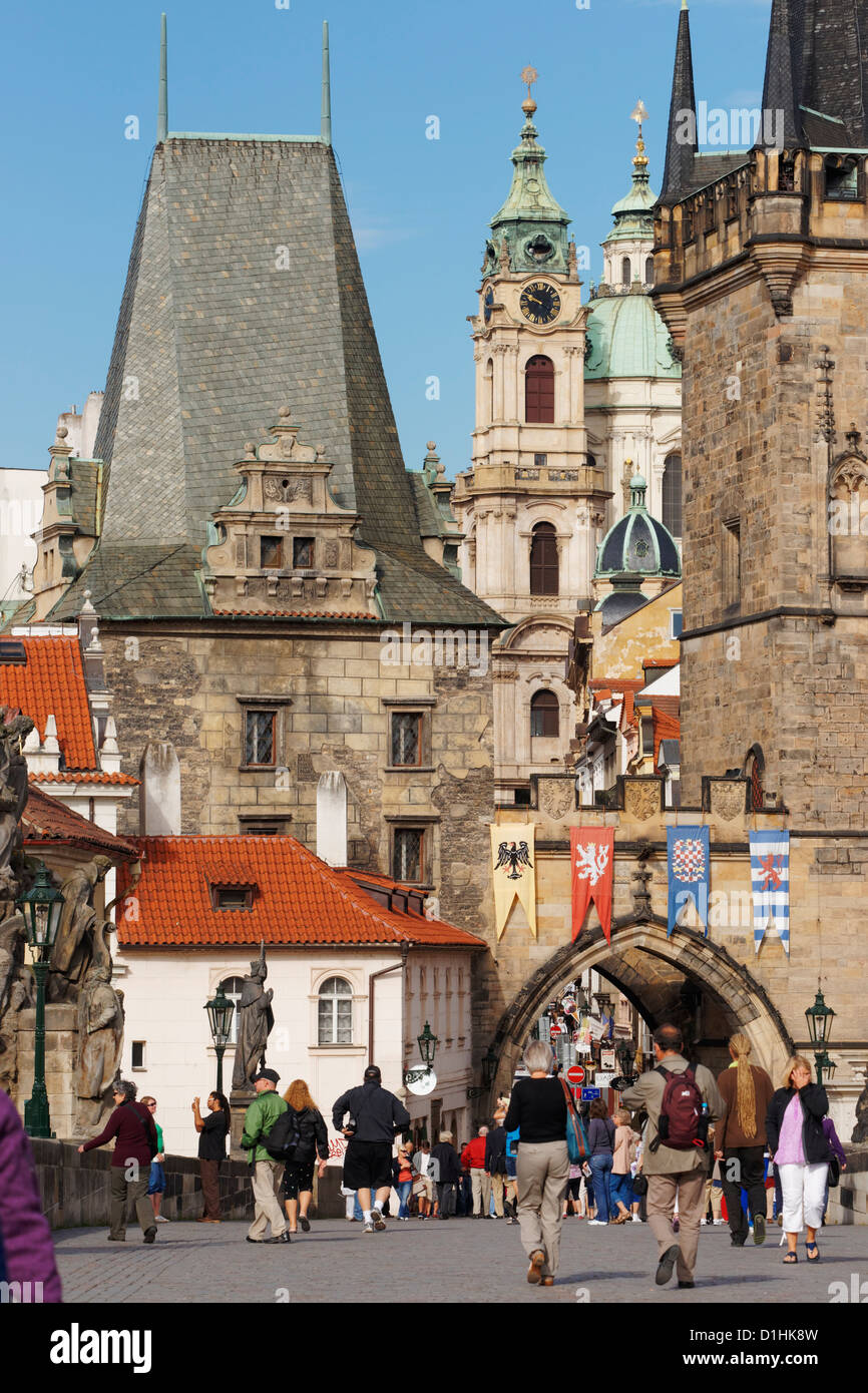 Tourists walking across Charles Bridge, Prague, Czech Republic. View to ...