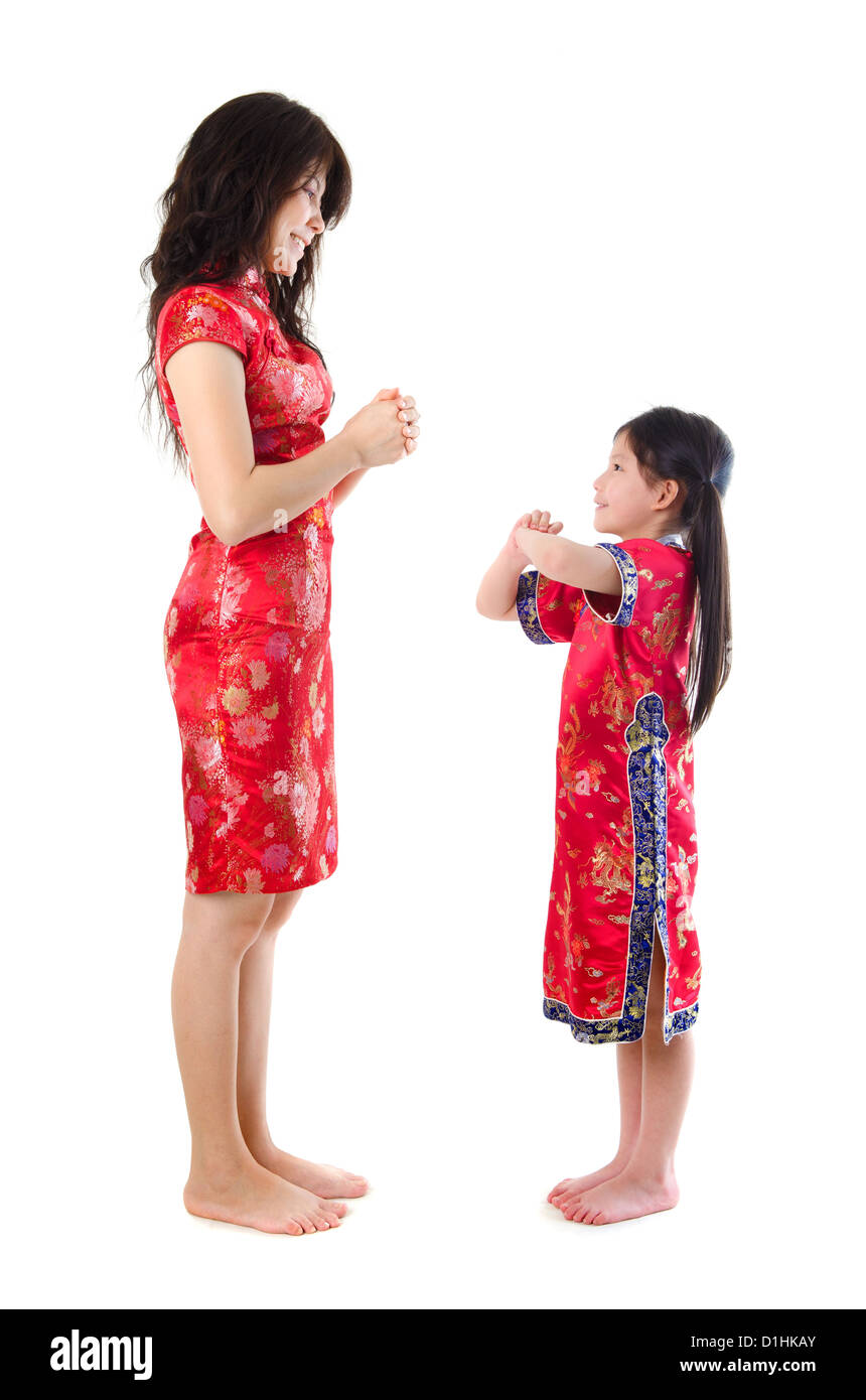 Chinese parent and child in traditional Chinese cheongsam greeting ...