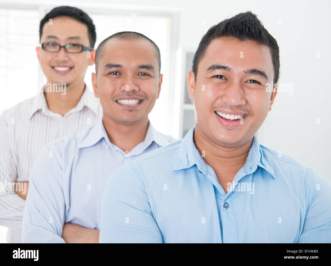 Southeast Asian business group standing in office Stock Photo - Alamy