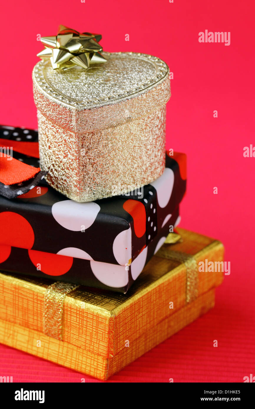 colorful stack of gift boxes on a pink background Stock Photo - Alamy