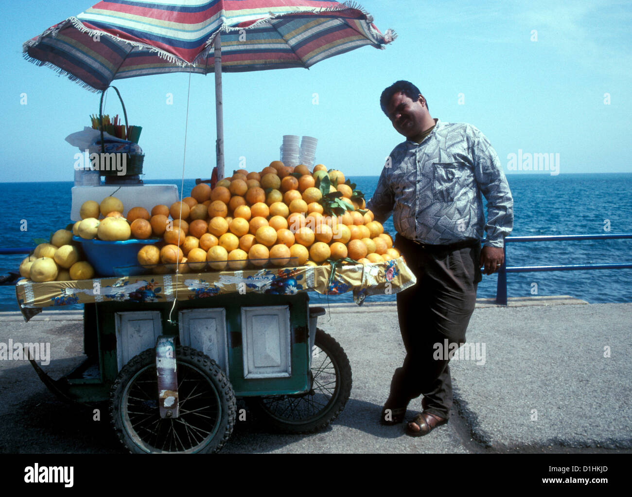 Orange-juice seller strikes a pose on Beirut waterfront Lebanon 1992 ...