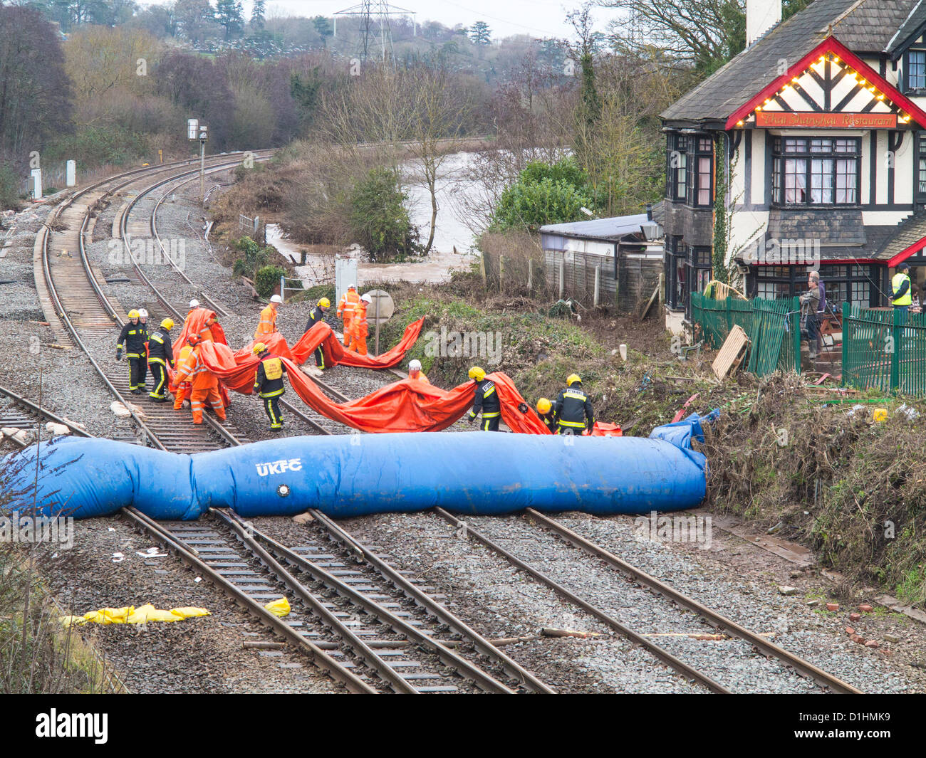 Firemen and Rail workers erect a second water dam across the Exeter to ...
